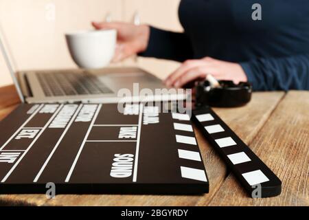 Female hands of scriptwriter working on laptop at desk on cupboard ...