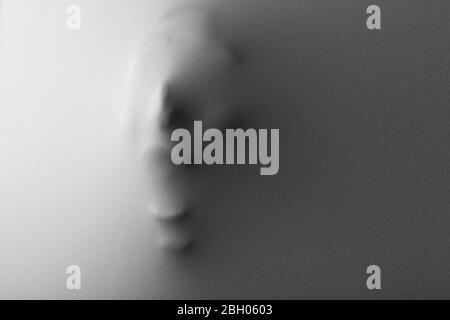 Screaming human face pressing through fabric as horror background Stock ...
