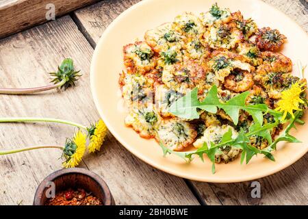 Deep fried dandelion flower on old wooden table Stock Photo - Alamy