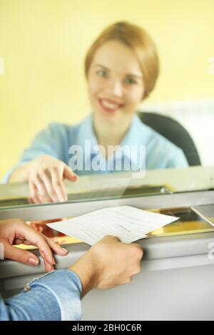 Teller window with working cashier. Concept of payment of utilities ...