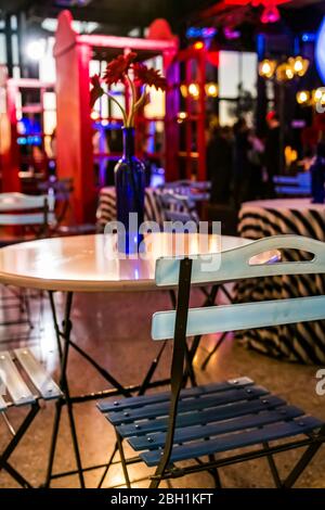 Cocktail tables at party event or gala dinner with flowers and moody ...