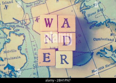 Wander word written in wooden blocks on a vintage travel map Stock ...