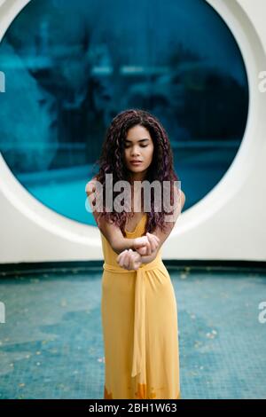 Young latin woman wearing summer clothes making fish face with lips ...