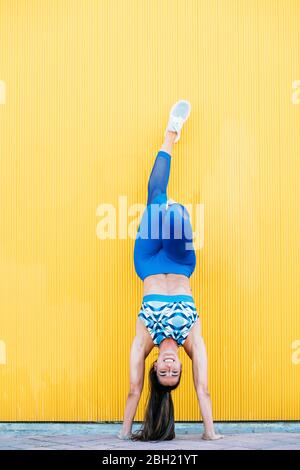 beautiful woman in yellow doing yoga. bali Stock Photo - Alamy