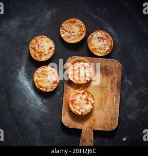 Little mini pizza with ham and cheese on a white Stock Photo - Alamy