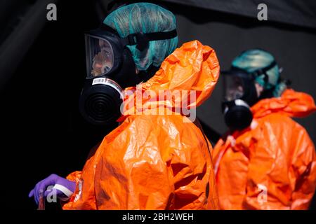 Medical workers dressed in protective suits as a preventive measure at ...