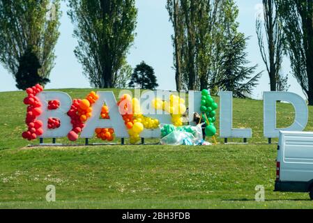 Basildon sign in Essex being decorated with coloured balloons to honour ...