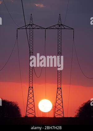 Hight voltage electric towers during sunset Stock Photo - Alamy