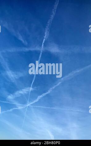 Air traffic, crossed contrails, blue sky Stock Photo - Alamy