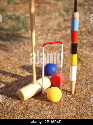 croquet mallet, wicket and colorful balls on a green lawn Stock Photo ...