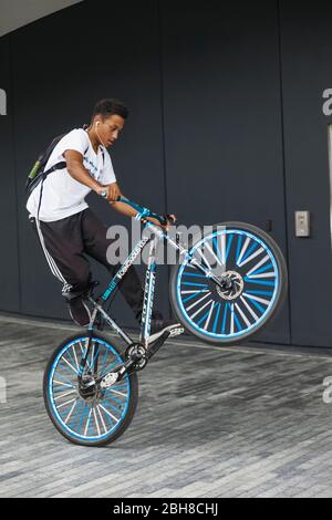 Young man on bicycle Stock Photo - Alamy