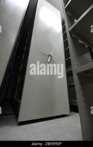 Wooden archive cabinet for storage with rows of small drawers with ...