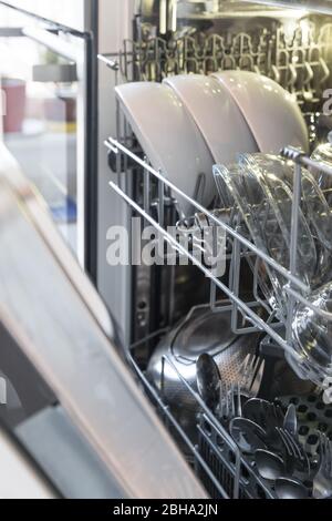 Dishes and cutlery on dishwashing machine. Clean dishes Stock Photo - Alamy