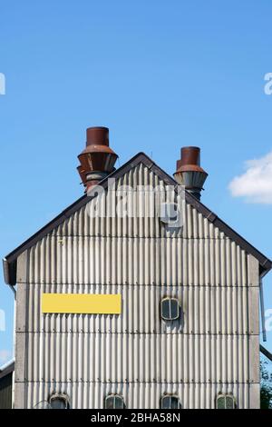 Facade of a building with metal chimneys Stock Photo - Alamy