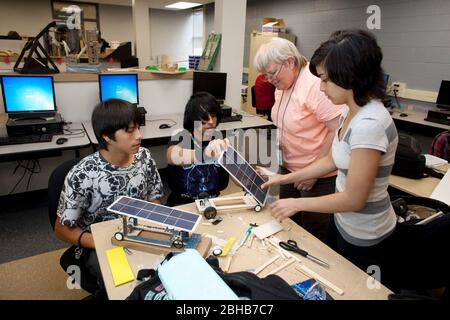 Students work together to build a model solar car as part of a class ...