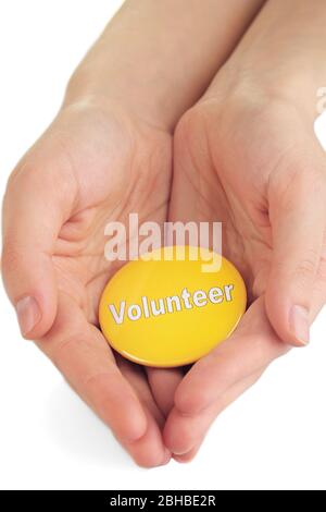 Round volunteer button in hands of girl close-up Stock Photo - Alamy
