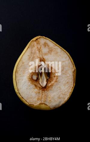 cut out section of an overripe pear on black background Stock Photo - Alamy
