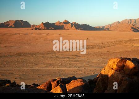 NAMIBIA Namib Desert Desert mountains and plains with pink and purple ...