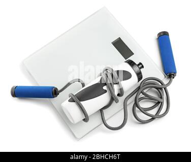 Weight scales with jumping rope on color background, closeup. Slimming ...