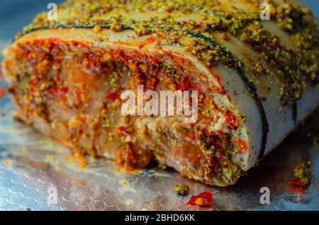 Boneless pork loin joint tied with string on the oven tray, raw meat ...