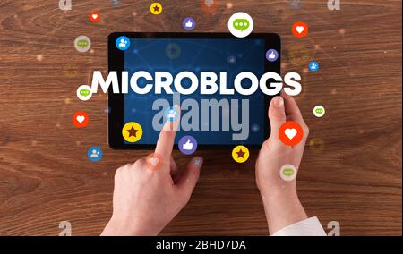 Close-up of a touchscreen with MICROBLOGS inscription, social media ...