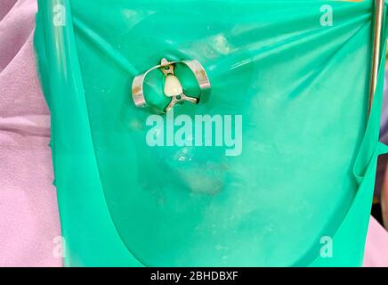 The green rubber dam isolation on tooth with metal clamp for dental ...