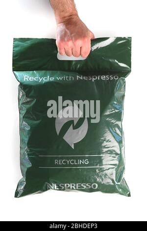 A Nespresso recycling bag in use with used coffee capsule pods on a ...
