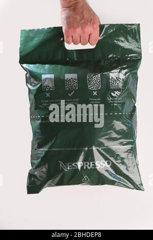 A Nespresso recycling bag in use with used coffee capsule pods on a ...