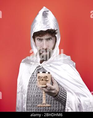 Young man in halloween wizard costume standing in dark forest with ...
