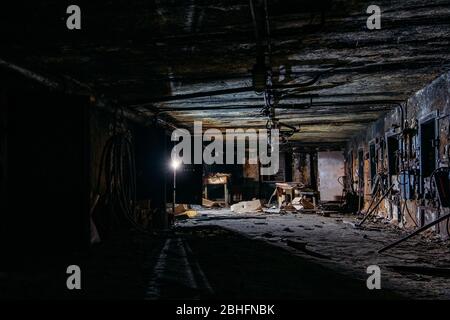 Burnt interior of industrial building basement. Walls in black soot ...