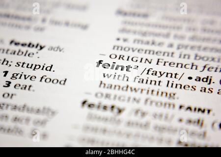 Word or phrase feint in a dictionary Stock Photo - Alamy