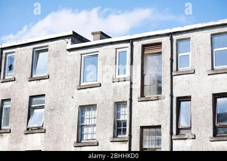Derelict council house in poor housing estate slum with many social ...