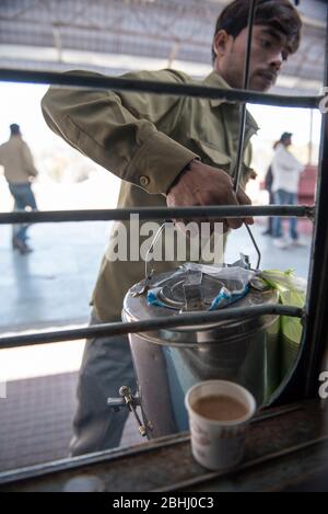 Mahoba / India 26 February 2017 Indian railway vendor selling tea to ...
