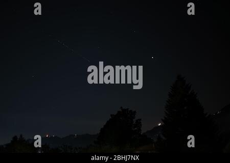 The night sky and the Elon Musk satellites visible in the frame on the ...