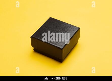 Mini black box product packaging isolated on yellow background Stock ...