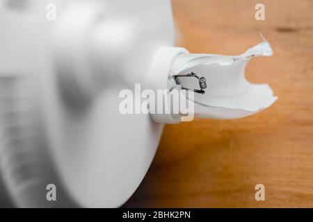 An exposed electrode and phosphor coated glass in a broken compact ...