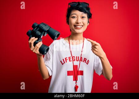 Young beautiful asian lifeguard girl wearing t-shirt with red cross ...