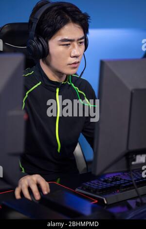 Young Chinese man playing esports Stock Photo - Alamy
