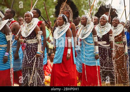 A Maasai choir dressed in traditional clothes and wearing their ...