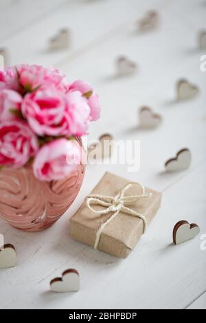 Small gift box wrapped pink and blue paper isolated on blue and pink ...