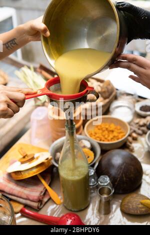 jamu traditional. close up of hand fill in the bottle with indonesian ...