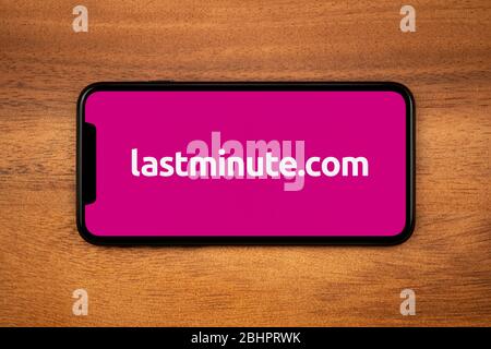 A smartphone showing the Lastminute.com logo rests on a yellow ...