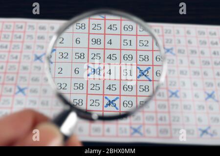 Female hand with magnifier analyzing lottery ticket, closeup Stock ...