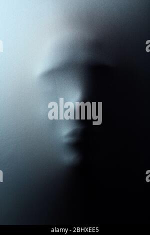 Human face pressing through fabric as horror background Stock Photo - Alamy