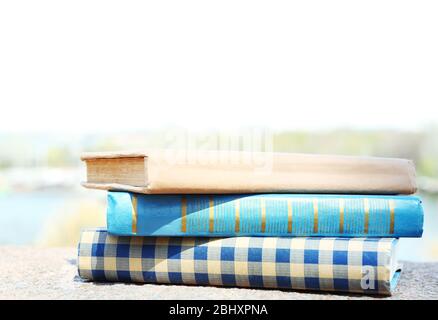 Stacked books on bright background Stock Photo - Alamy