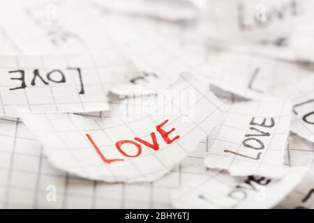 Word LOVE written on torn paper on sheet of paper background Stock ...