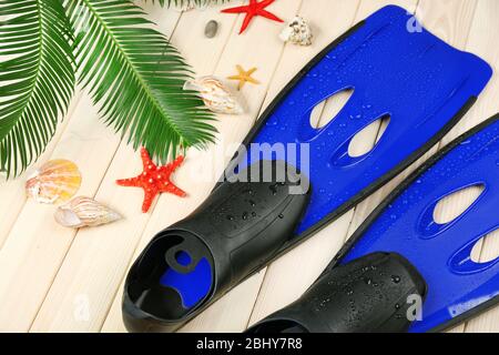 Sea composition with flippers and shells on wooden table close up Stock ...