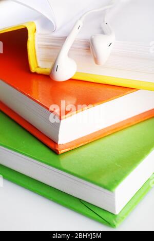 Earphones and books on table, closeup Stock Photo - Alamy