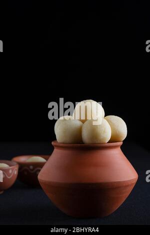 Mouth watering white rasgullas kept in earthen handi and bowls Stock ...