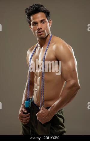 Man standing with a skipping rope around his neck Stock Photo - Alamy